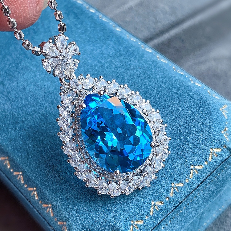 Water droplet shaped necklace with blue, sparkling topaz inlaid ...